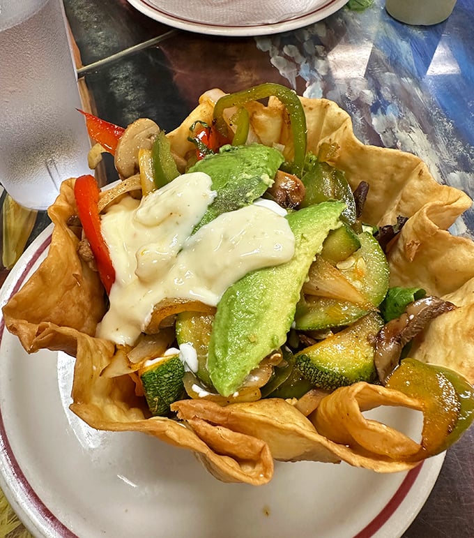 A garden in a tortilla bowl – crispy edges giving way to fresh vegetables, avocado, and melted cheese. Salad that doesn't feel like punishment!