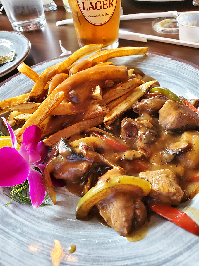 Tender chunks of beef, mushrooms, and peppers bathed in savory gravy alongside golden fries—comfort food that hugs your soul from the inside.
