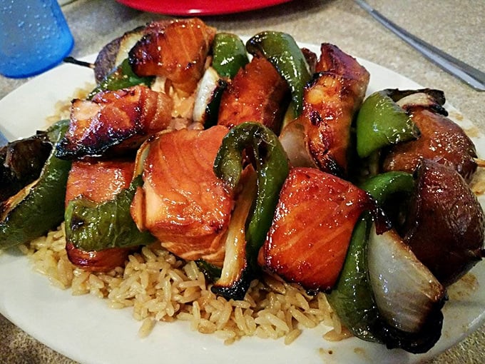 These teriyaki salmon kabobs aren't just dinner&mdash;they're edible architecture, with each glazed chunk glistening like jewels atop a rice foundation.