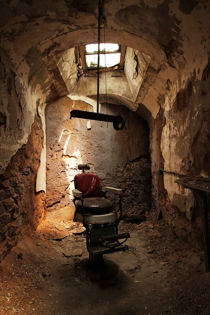 This isn't your neighborhood salon. The prison barber chair sits eerily illuminated by natural light, waiting for customers who checked out decades ago.