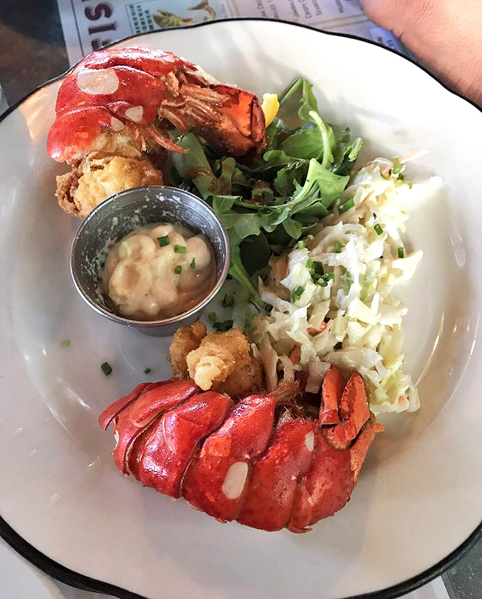 Lobster tails that got the Southern treatment &ndash; crispy-fried and served with slaw that cuts through the richness like a well-timed punchline.