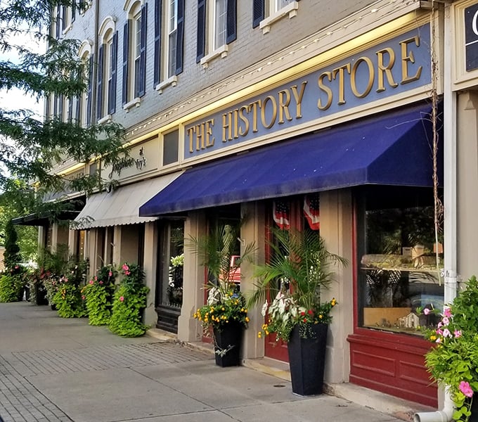 The History Store's welcoming facade and colorful planters invite passersby to step back in time without spending tomorrow's pension check.