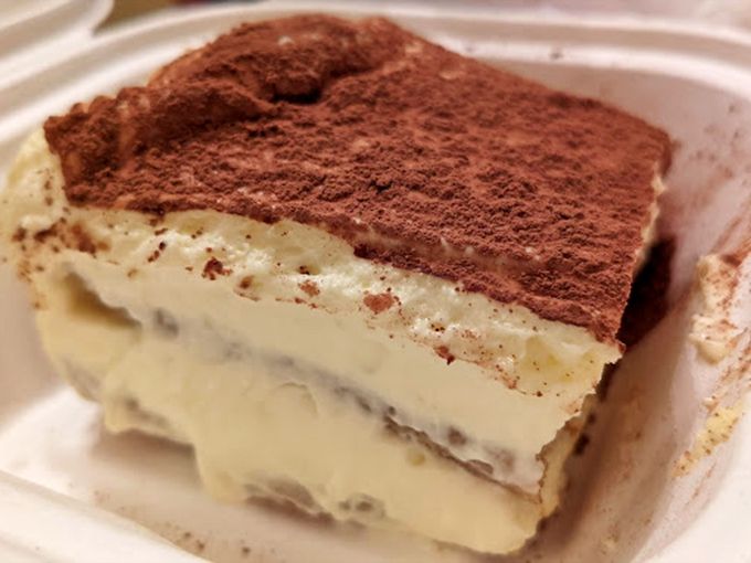 Tiramisu so tall and creamy, it's basically edible architecture dusted with cocoa dreams and coffee-soaked happiness.