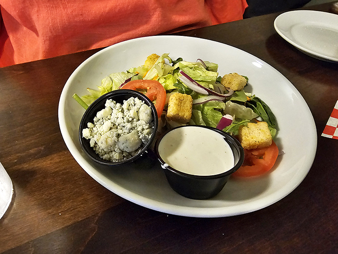 Even the salad gets the royal treatment here. That blue cheese and ranch on the side aren't condiments&mdash;they're transformation potions for your greens.