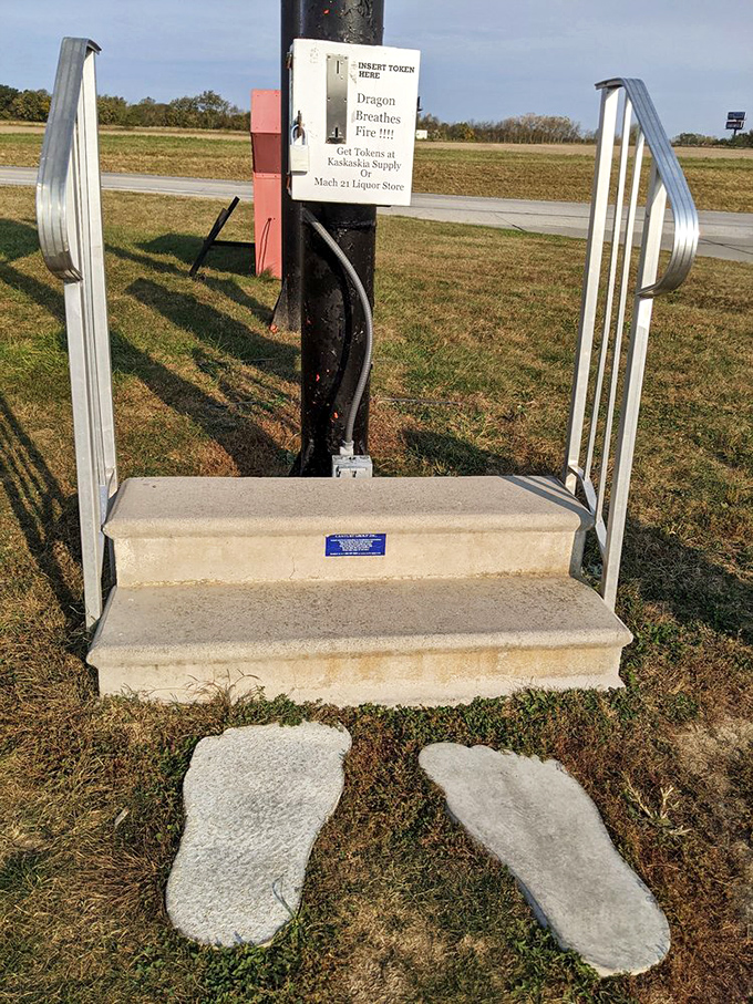 The gateway to dragon fire: two concrete footprints lead visitors to the token platform where the magic begins.