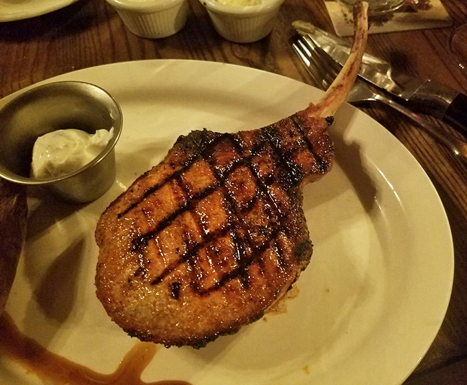 This isn't just a pork chop&mdash;it's a monument to meat, grilled with perfect crosshatch marks that should be in a museum of culinary art.