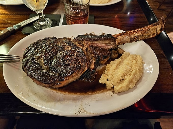 The tomahawk steak arrives like a prehistoric declaration of carnivorous intent&mdash;a bone-in masterpiece with a side of mashed potatoes that makes you wonder why anyone would ever choose chicken.