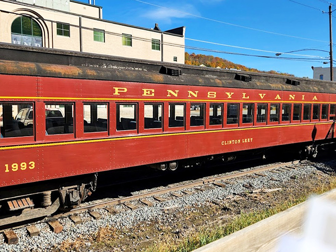 The Clinton Leary coach car, resplendent in Pennsylvania Railroad crimson, waits patiently on the siding&mdash;a rolling museum piece that still earns its keep daily.