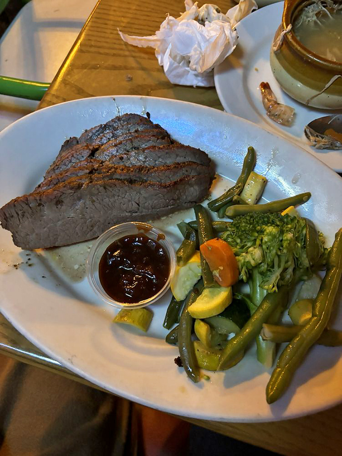 The tri-tip looks like it was smoked by someone who learned the craft from three generations of pitmasters, with vegetables that aren't just an afterthought.