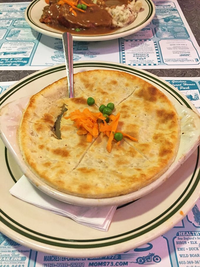 Pot pie perfection&mdash;golden, flaky crust hiding a steamy treasure of savory filling. The carrots and peas peeking through are just showing off.
