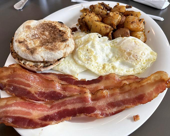 The breakfast trinity: perfectly cooked eggs, crispy bacon, and a biscuit worthy of your Southern grandmother's approval. Simple perfection doesn't need to shout.