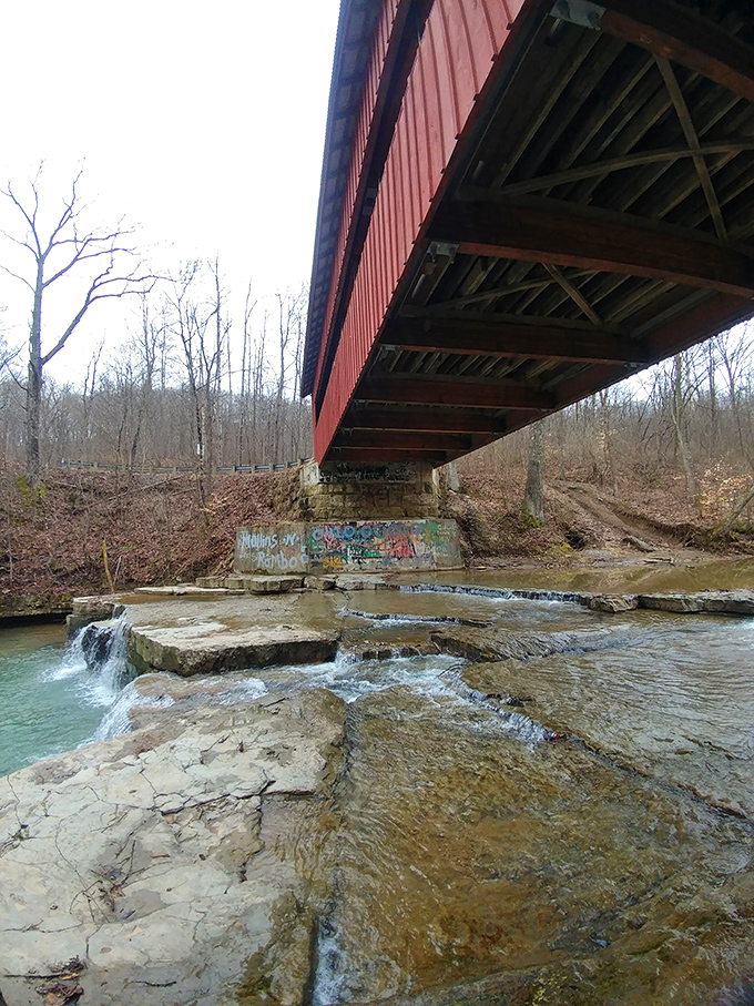 Nature's watercolor painting beneath man's architecture. The stone foundation has witnessed countless seasons of flowing water.