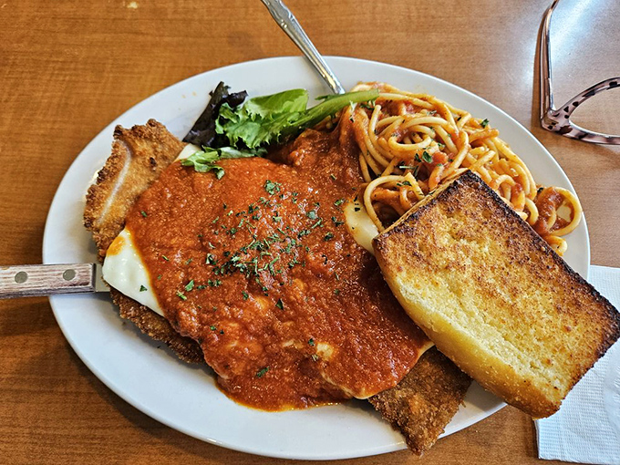 Veal parmesan so generous it practically spills off the plate like edible abundance personified perfectly.