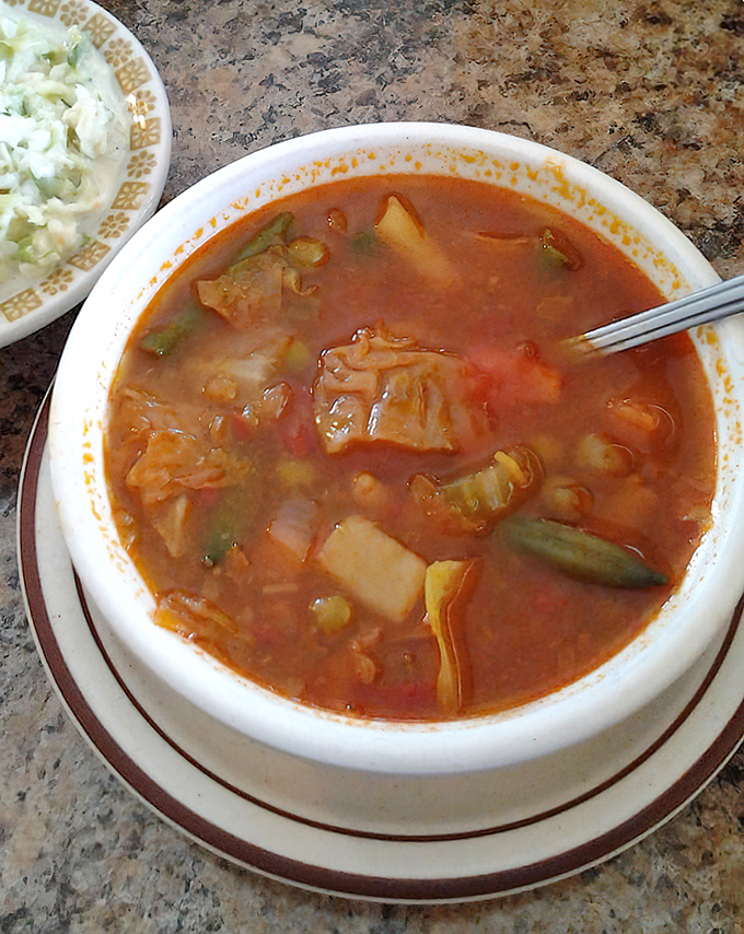 A bowl of vegetable soup that looks like someone's grandmother spent all day chopping, simmering, and seasoning. Comfort in liquid form.
