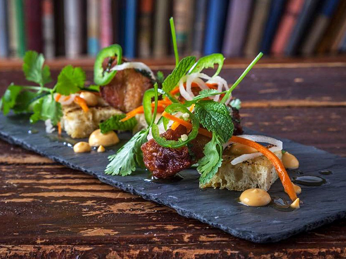 Vietnamese pork belly that makes you question every other pork dish you've ever loved. Those vibrant garnishes aren't just pretty&mdash;they're flavor fireworks.