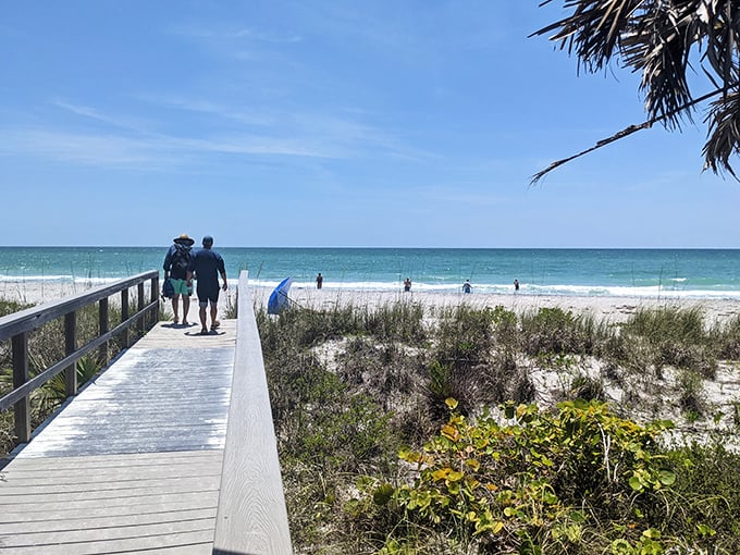 The wooden boardwalk offers civilized passage to paradise, where two visitors are about to have a much better day than the rest of us.