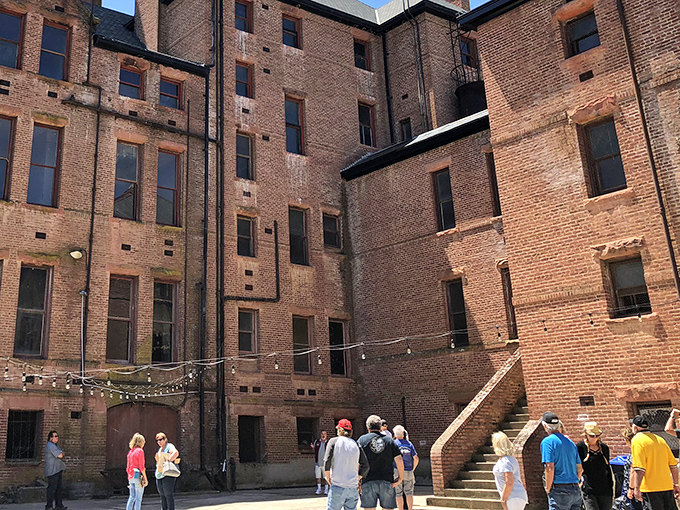The castle's inner courtyard hosts tours where visitors absorb history while secretly wondering if they just felt something brush past them.