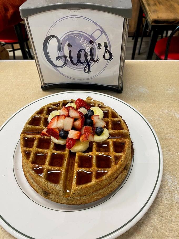 This Belgian waffle topped with fresh berries and banana slices is what breakfast dreams are made of. Diet plans surrender at the door.
