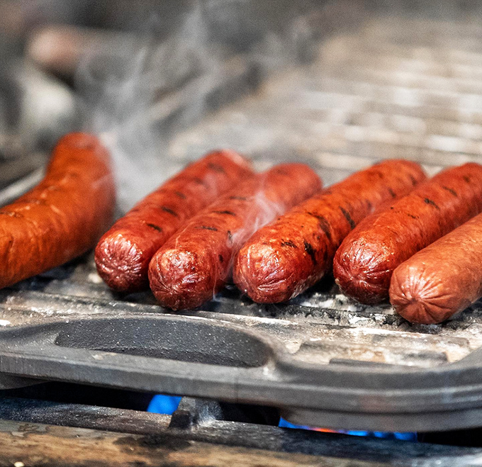 These sausages sizzle with promise, their skin taut and glistening like they're auditioning for the lead role in a meat lover's dream.