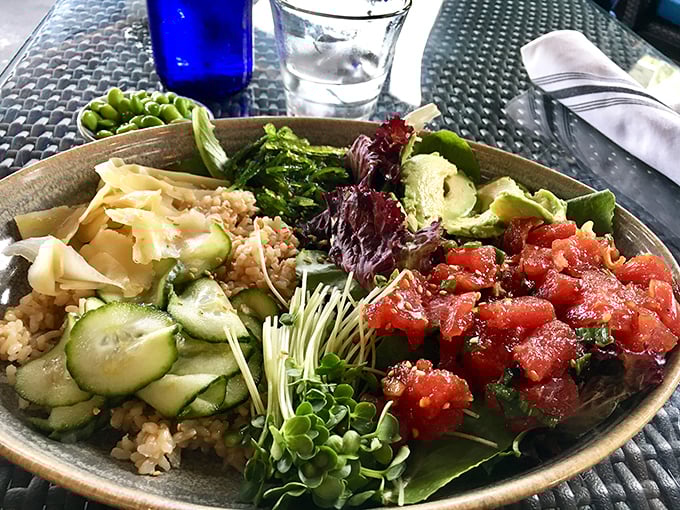 A bowl that brings together fresh ingredients like the United Nations of flavor. Rice, veggies, and perfectly prepared fish create edible diplomacy.