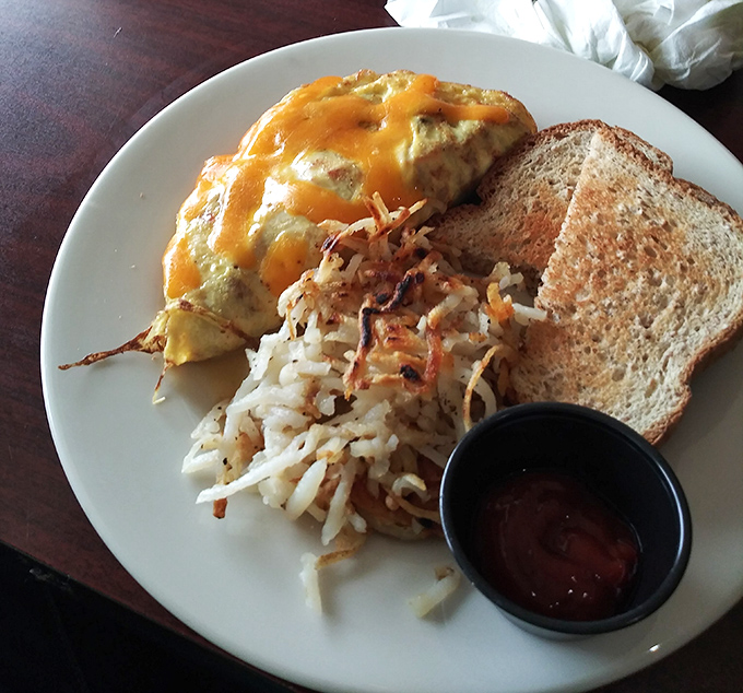 Breakfast doesn't get more comforting than this cheesy omelet with crispy hash browns and toast. The kind of plate that makes Monday feel like Saturday.