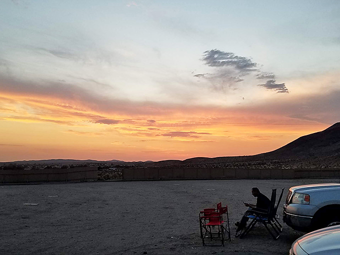 Desert sunset paints the perfect backdrop as moviegoers settle in with chairs and blankets for nature's pre-show spectacle.