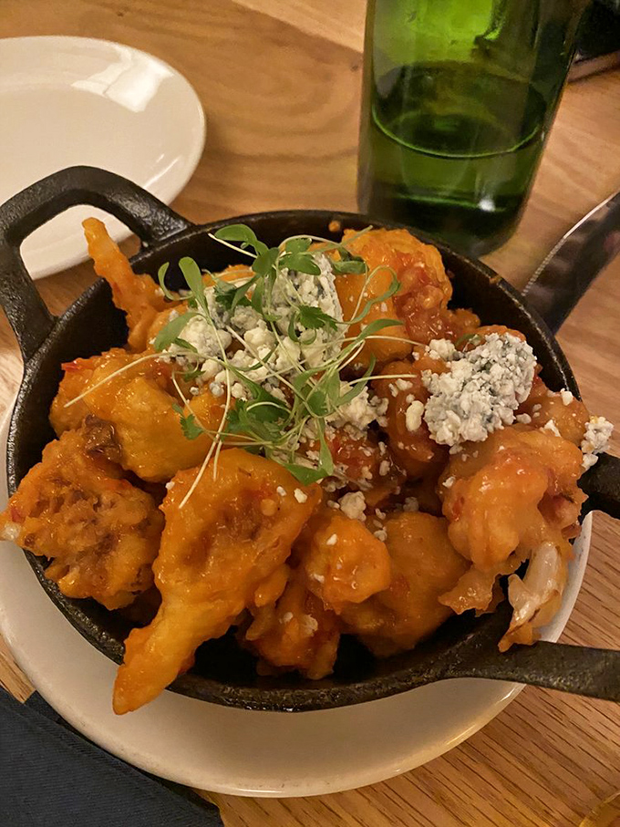 These buffalo wings arrive sizzling hot, promising the kind of messy, delicious experience that requires extra napkins.