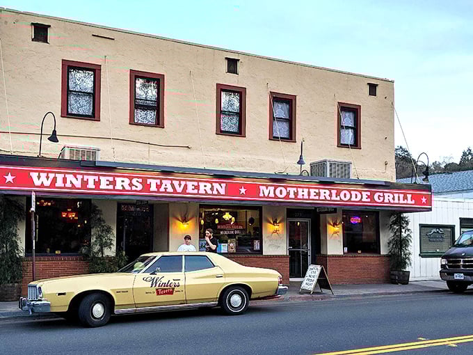 Winters Tavern serves up comfort food alongside local gossip, with that vintage yellow car outside suggesting your meal might arrive via time machine.