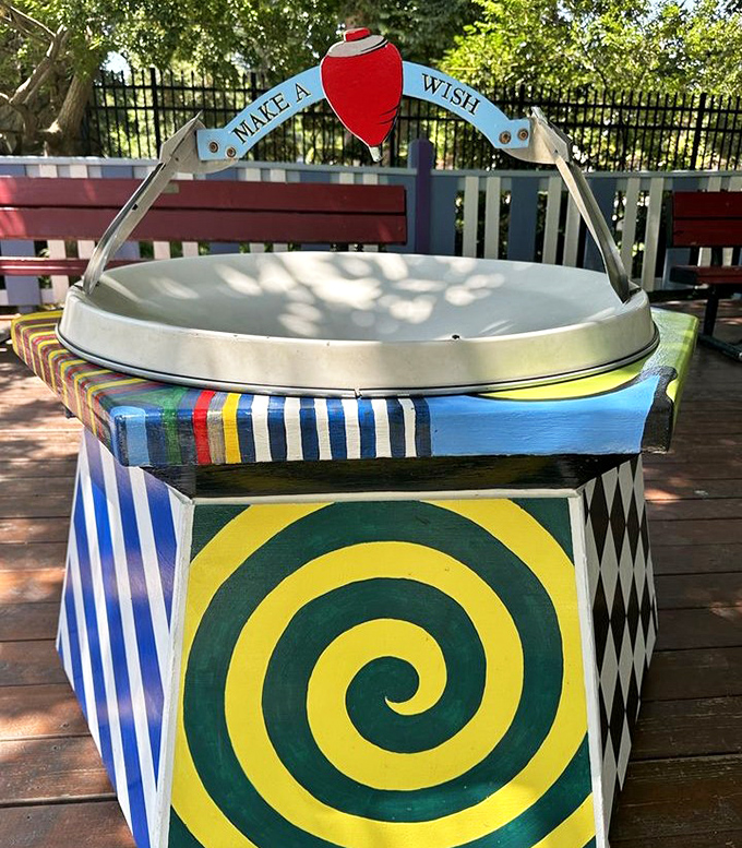 "Make a Wish" invites the colorful well. In a world of digital everything, there's something magical about a coin toss and a moment of hope.