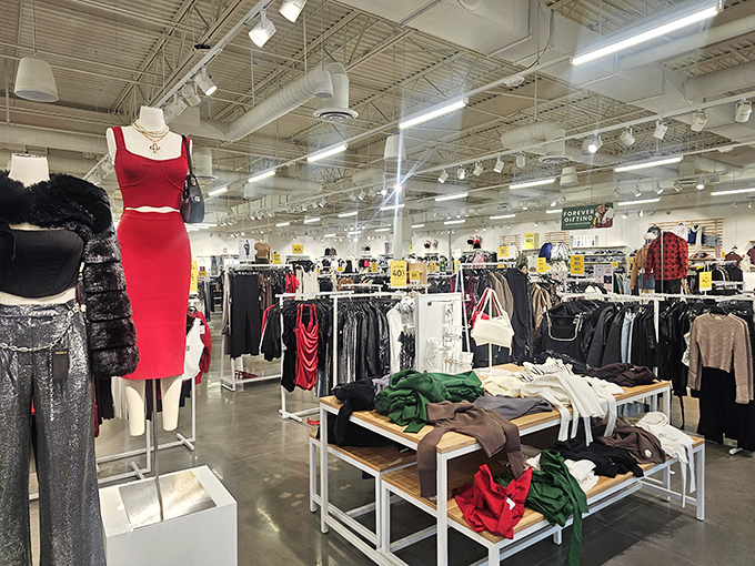 The red dress commands attention like a traffic light saying "Stop and shop!" while surrounding racks promise treasures for those willing to hunt.