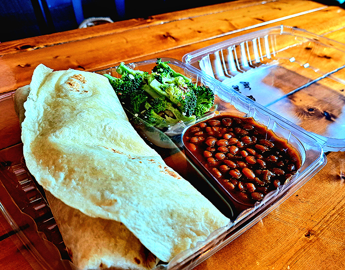 That wrap isn't just holding meat&mdash;it's cradling barbecue treasure alongside fresh broccoli and beans that somehow make you feel virtuous while indulging.