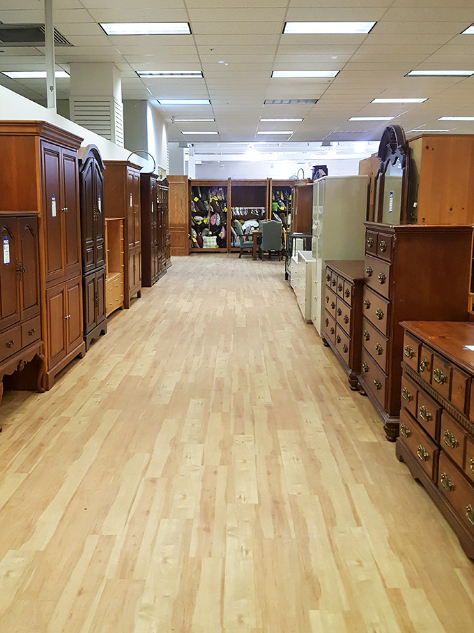 Solid wood wardrobes and dressers line this aisle like sentinels guarding vintage craftsmanship. Each piece whispers stories of dinners served and holidays celebrated. 