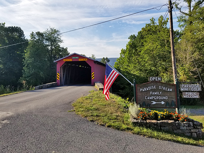 Stars and stripes meet historic craftsmanship. Paradise Stream Family Campground neighbors this wooden sentinel, making it more than just a crossing.