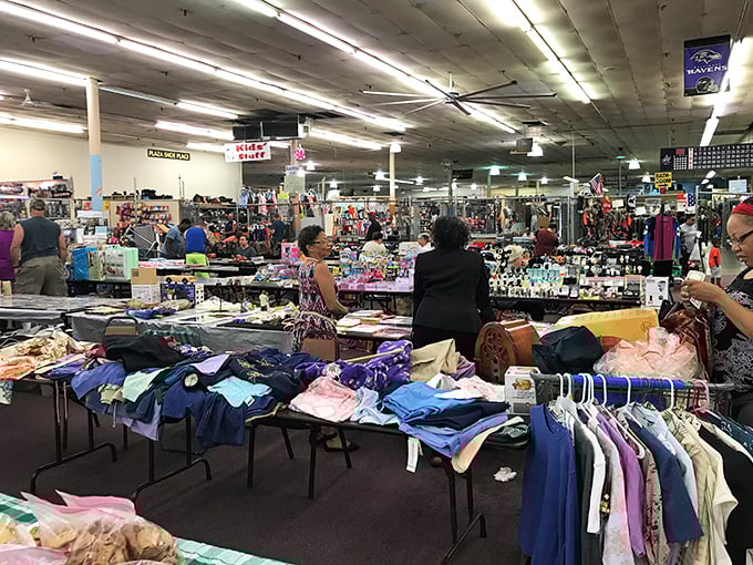 Ravens banners hang proudly overhead as shoppers navigate a colorful landscape of clothing, collectibles, and conversation.