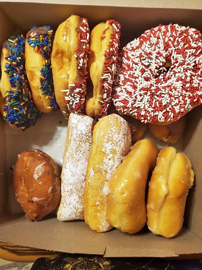 A box of joy featuring sprinkle-topped donuts alongside powdered classics&mdash;proof that happiness can indeed be purchased for less than $10.