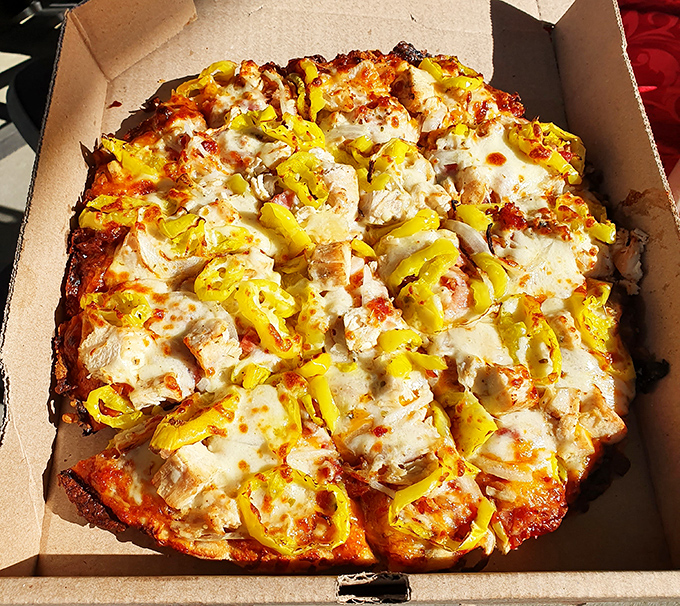 The legendary BBQ chicken pizza, with its golden crust and bright banana peppers, proves that sometimes the best culinary innovations happen far from fancy food labs.