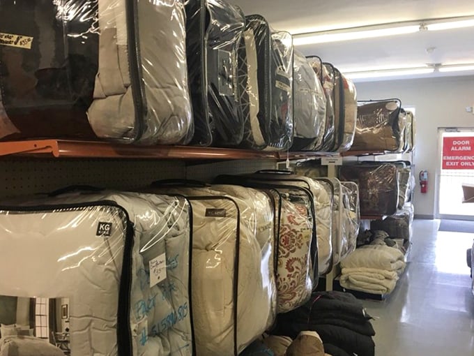 Mattress mountain! Gently used bedding stacked to the ceiling proves one person's spring cleaning becomes another's fresh start.