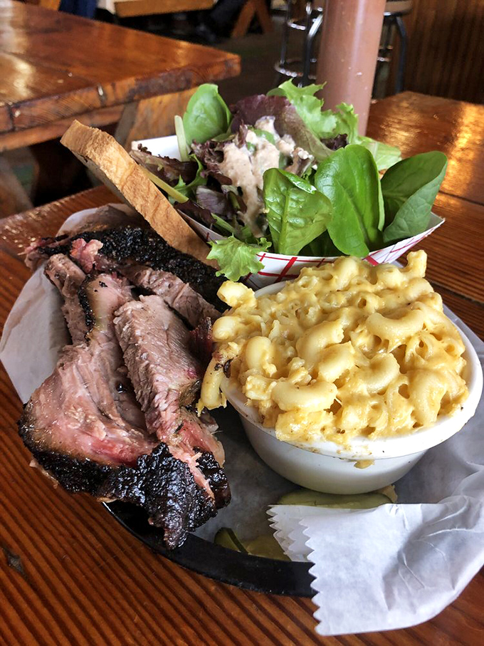 Brisket that's been kissed by smoke until it blushed that perfect pink ring, with sides that refuse to be overshadowed.