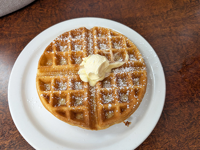 This Belgian waffle doesn't need a passport to impress&mdash;just powdered sugar snow and a butter pat melting like a summer romance.