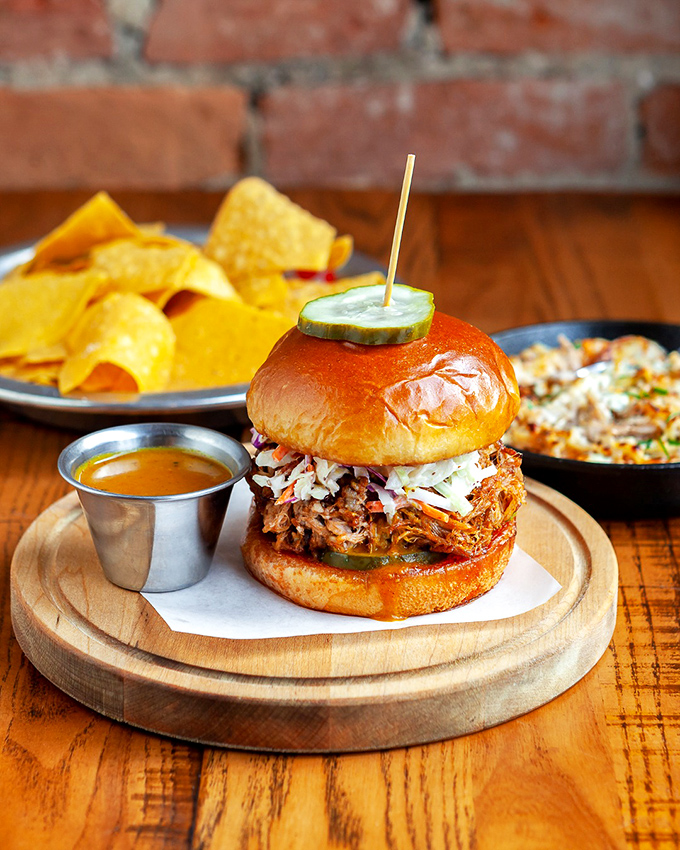 Meet the sandwich that's been breaking hearts across Cincinnati&mdash;tender braised pork topped with slaw and a pickle spear standing guard.