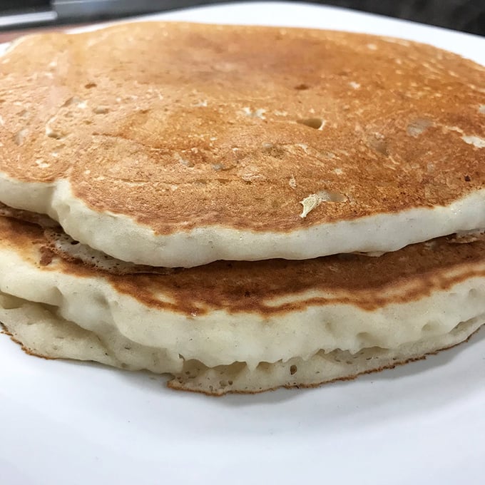 Pancakes so fluffy they could float away if not anchored by their golden-brown exterior. The breakfast equivalent of a perfect pillow.