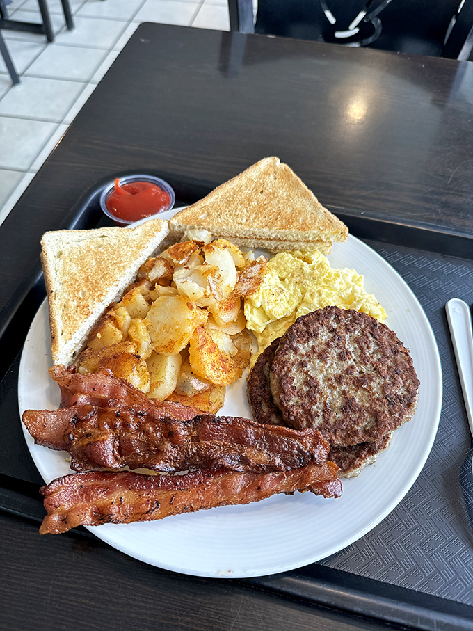 Breakfast of champions: crispy bacon, golden hash browns, and a burger patty that would make Rocky himself ready to tackle those museum steps.