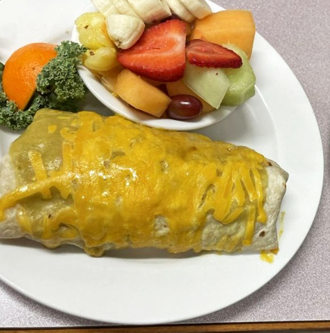 The breakfast burrito's melted cheese blanket protects its precious contents, while fresh fruit brings color to the party like welcome weekend guests.