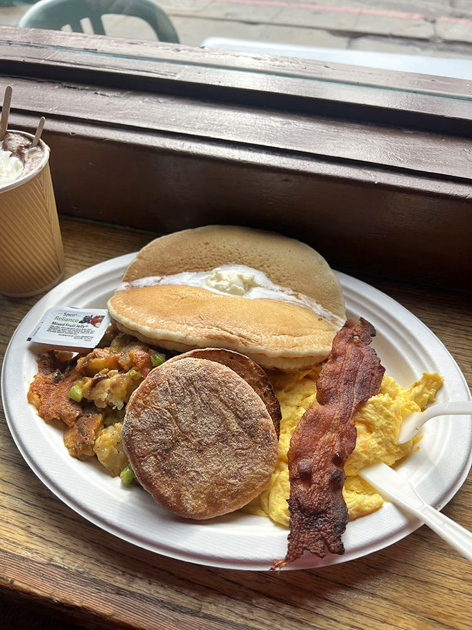 The breakfast platter that answers the eternal question: "Why choose between pancakes, eggs, and bacon when you can have the holy trinity on one plate?"