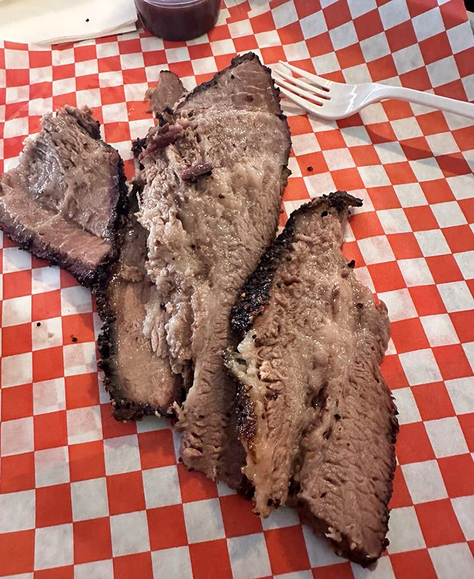 Brisket with that telltale pink smoke ring—nature's way of saying "patience rewarded." Fork optional, napkins mandatory.