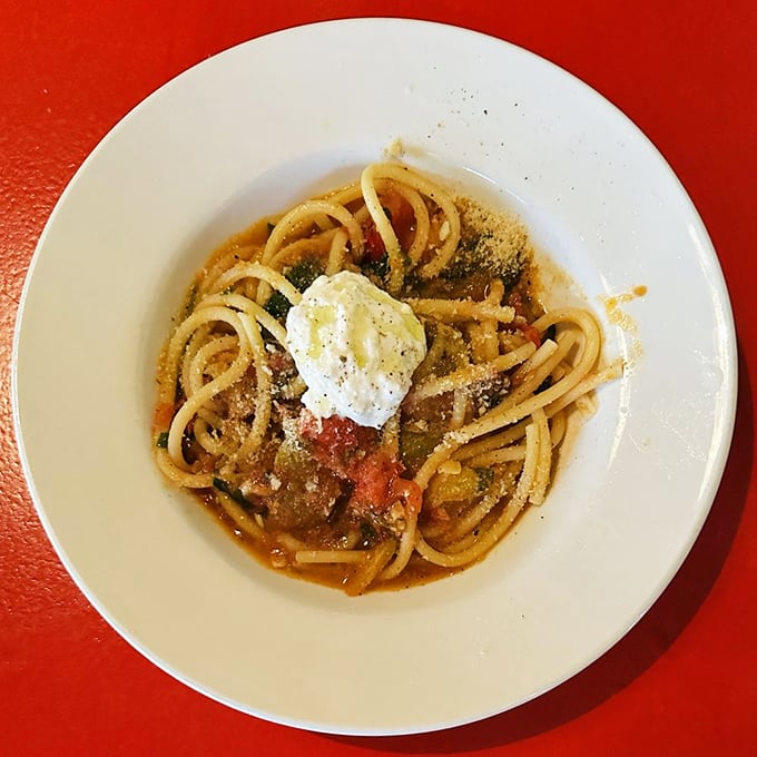 Pasta perfection in its simplest form. This bucatini comes crowned with a cloud of fresh cheese that melts into the sauce with each twirl of your fork.