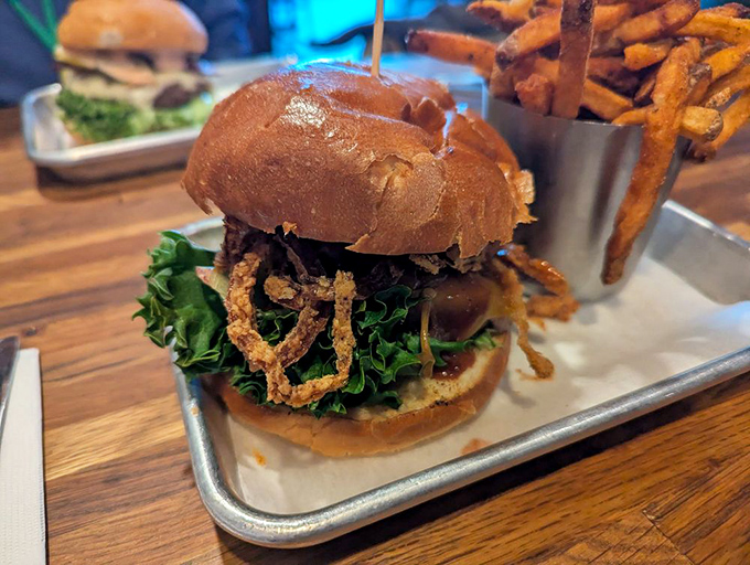 This isn't just a burger—it's an architectural marvel of beef, bun, and toppings that requires both hands, several napkins, and absolutely zero shame.