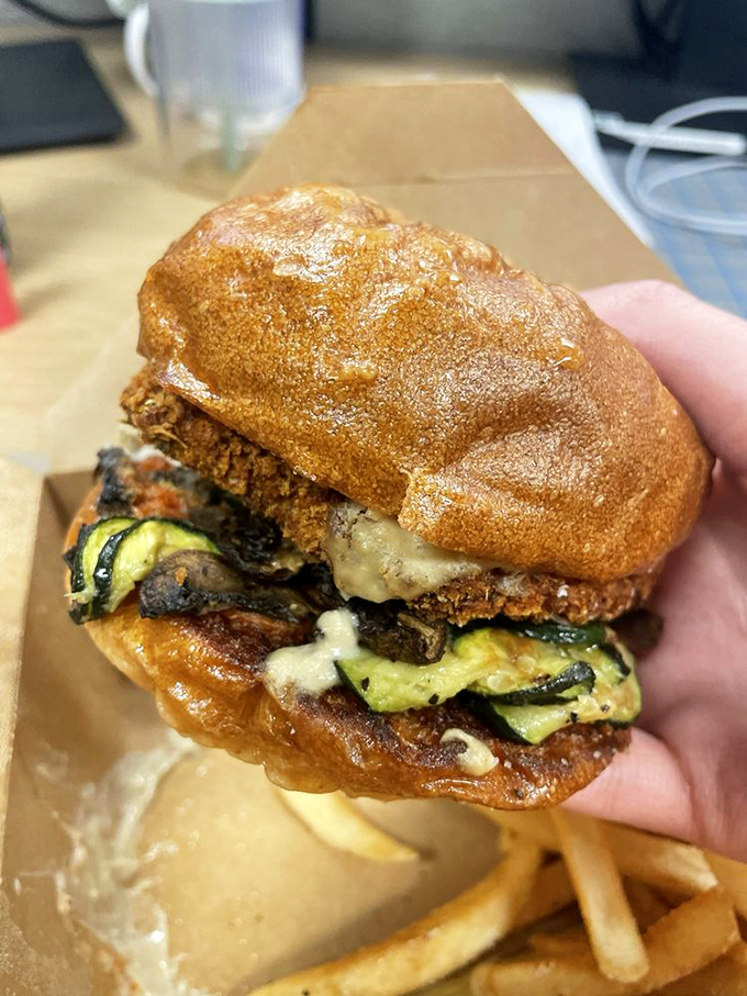 This isn't just a burger; it's an architectural marvel of zucchini, melted cheese, and a bun that deserves its own appreciation society.