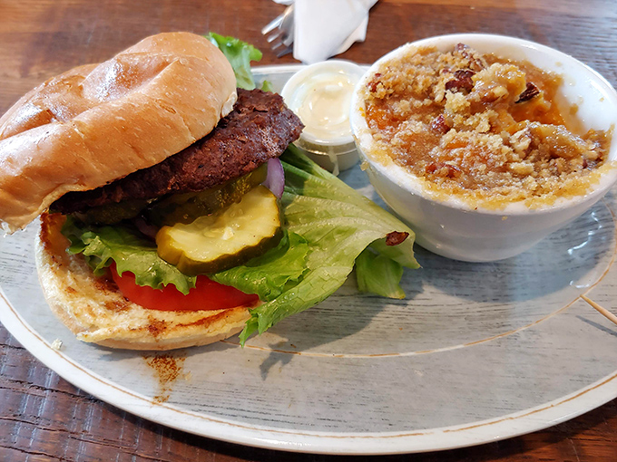 This isn't just a burger&mdash;it's architecture with attitude. That side dish appears to be apple crisp having an identity crisis as a savory option.