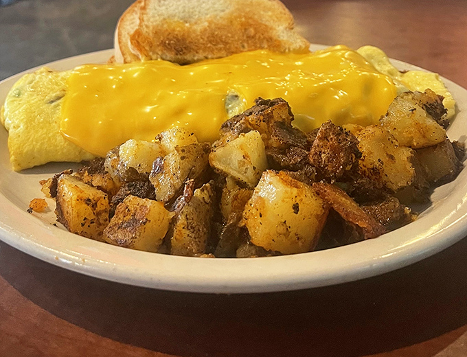 An omelet that could make you forget every other egg dish you've ever had. That golden cheese blanket is hiding treasures worth discovering.